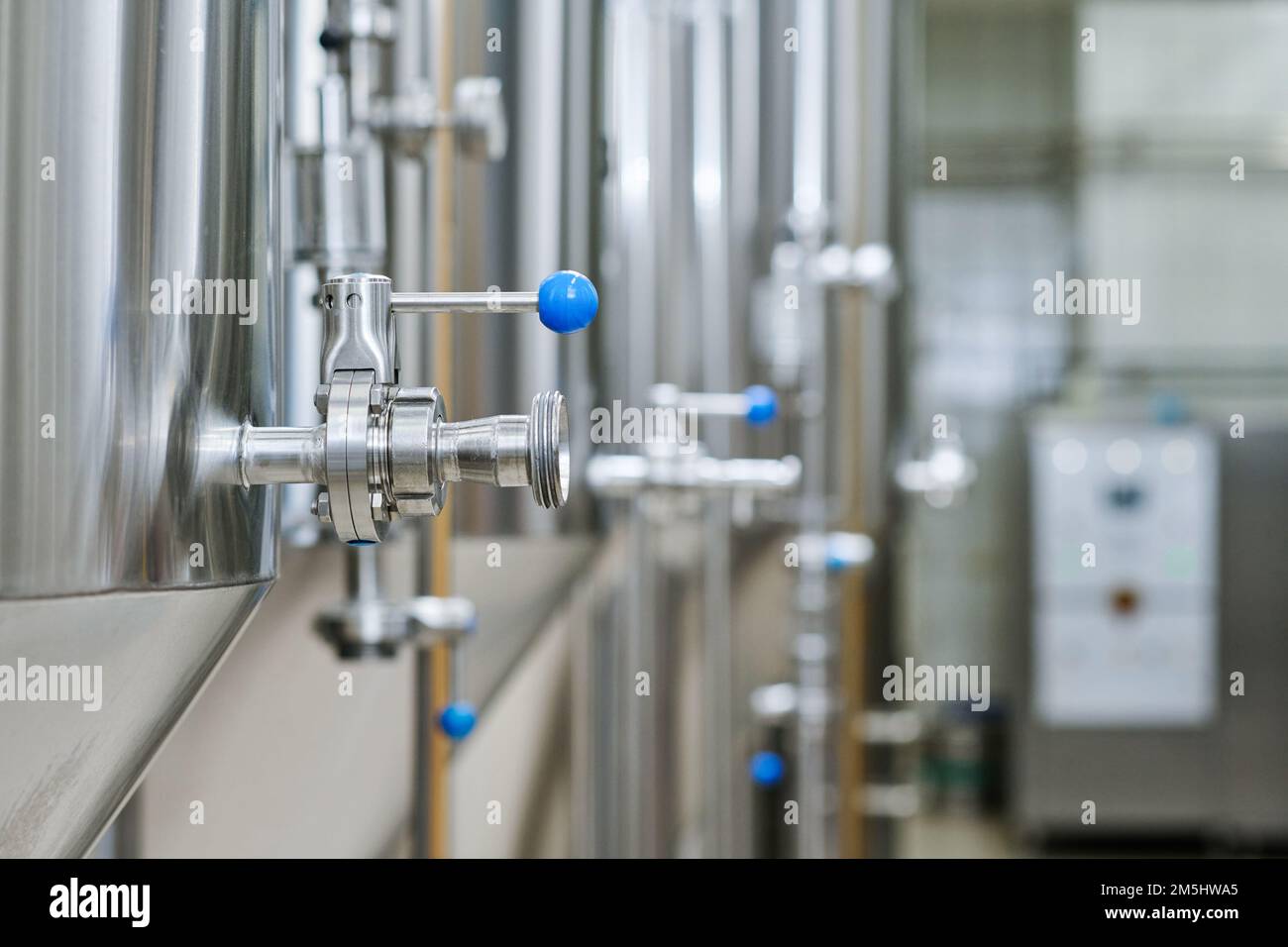 Close-up of steel tank with control lever to control the processing of ...