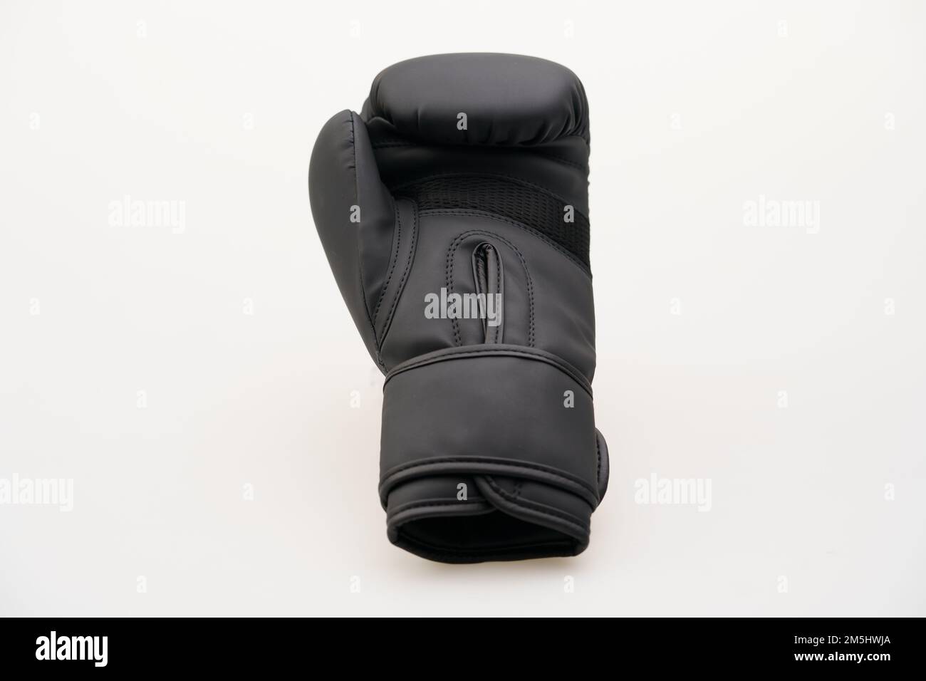 A single black boxing glove isolated on a white background Stock Photo ...