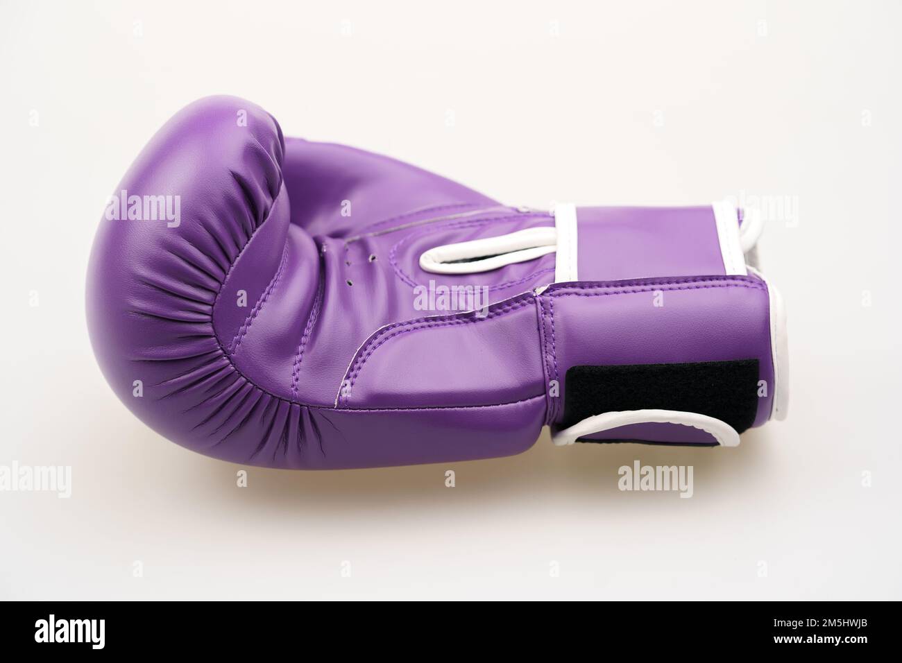 A single purple boxing glove isolated on a white background Stock Photo ...