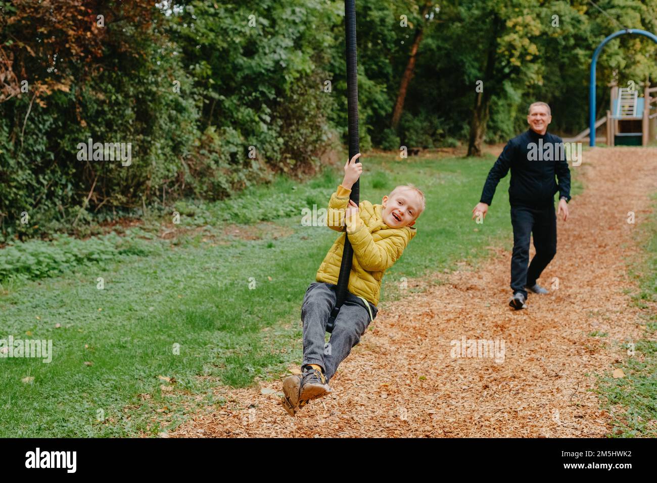 Kid Bungee jumping in the Autumn Forest Stock Photo - Alamy