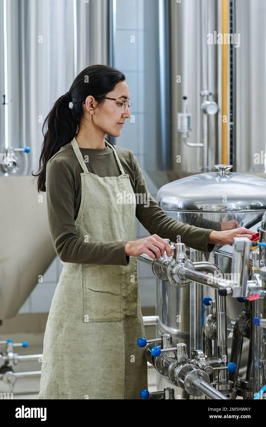 Professional engineer controlling the work of equipment for production ...