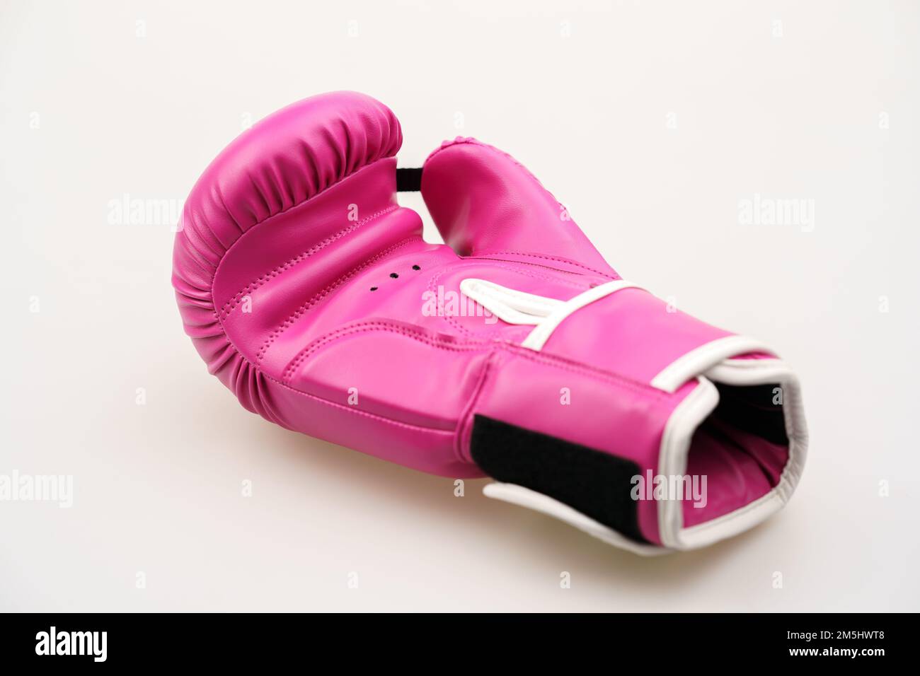 A single pink boxing glove isolated on a white background Stock Photo ...