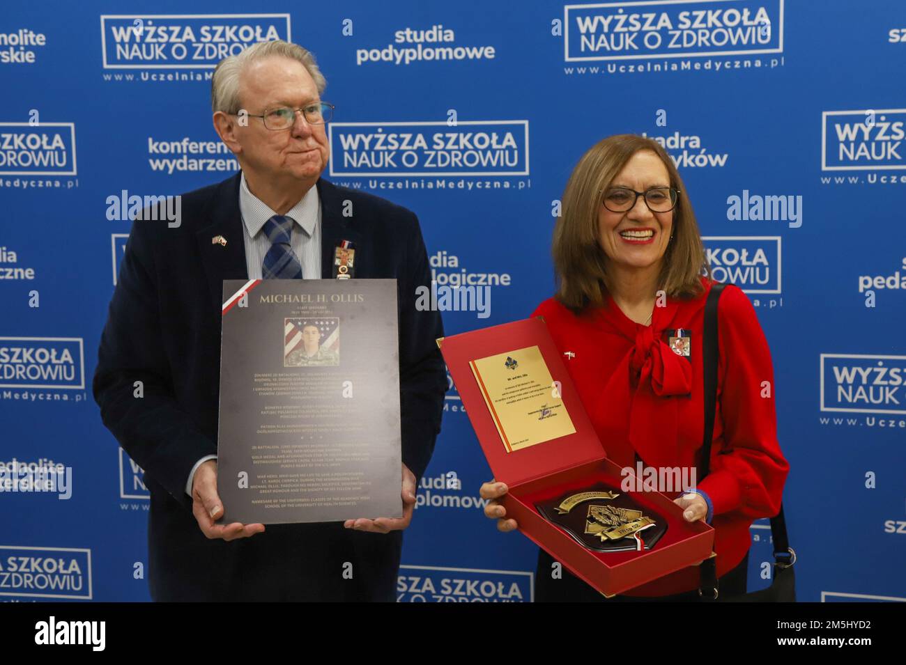 Bob and Linda Ollis, parents of Staff Sgt. Michael Ollis, are presented ...