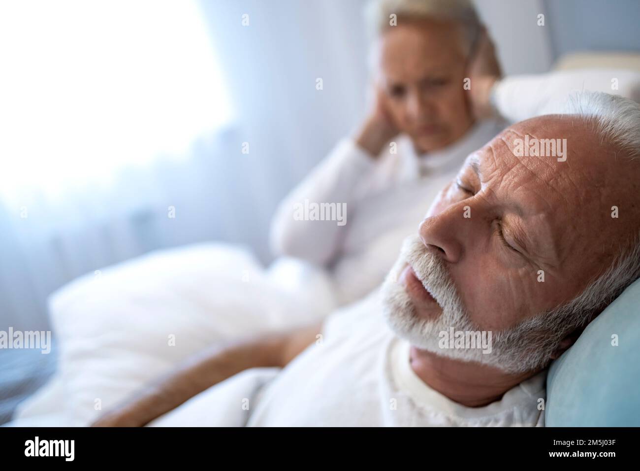 Snoring man and his woman in bedroom. Couple sleeping in bed Stock ...