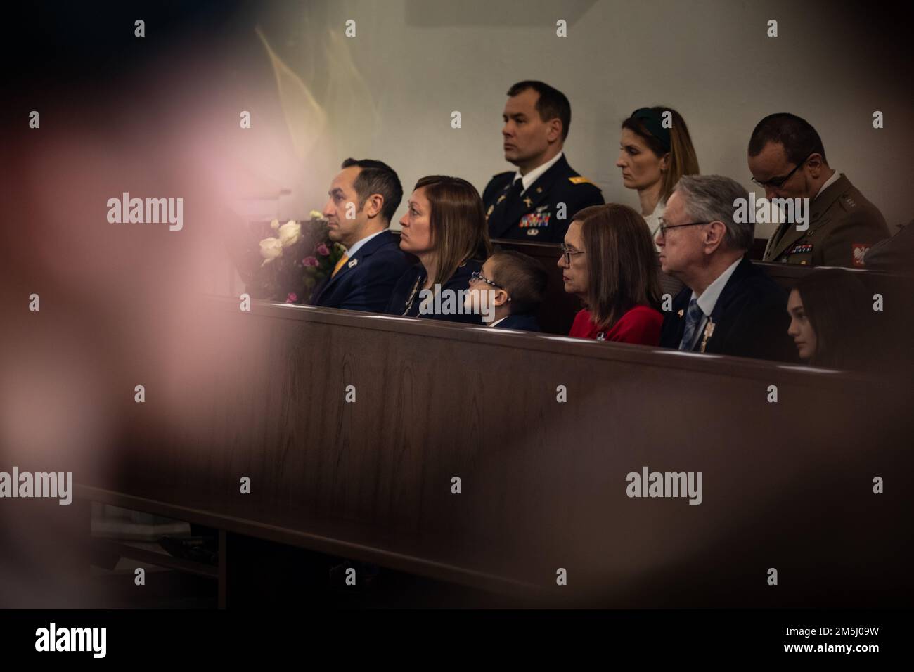 The Ollis family listens to the liturgy during a ceremony in honor of ...