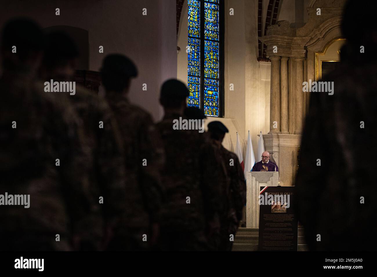 U.S. Army Lt. Col. Jerzy Rzasowski, a chaplain, reads the holy gospel ...