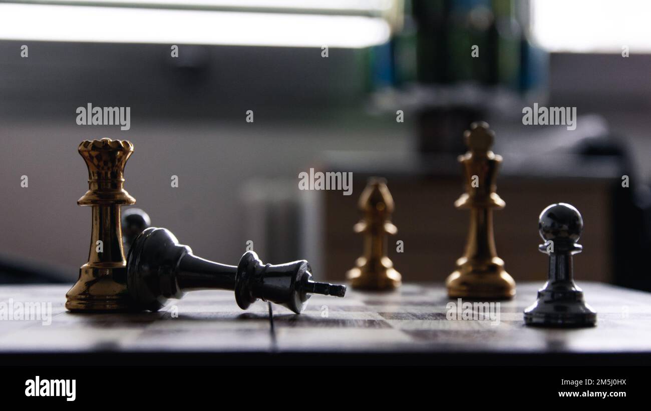 A closeup shot of the king chess peace fallen on the chess board ...