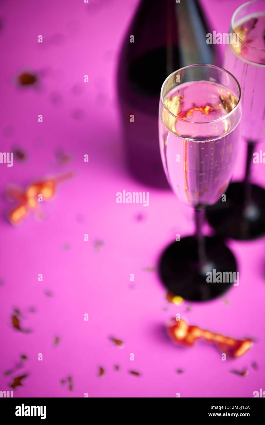 Two glasses full of sparkling champagne wine with golden decoration ...