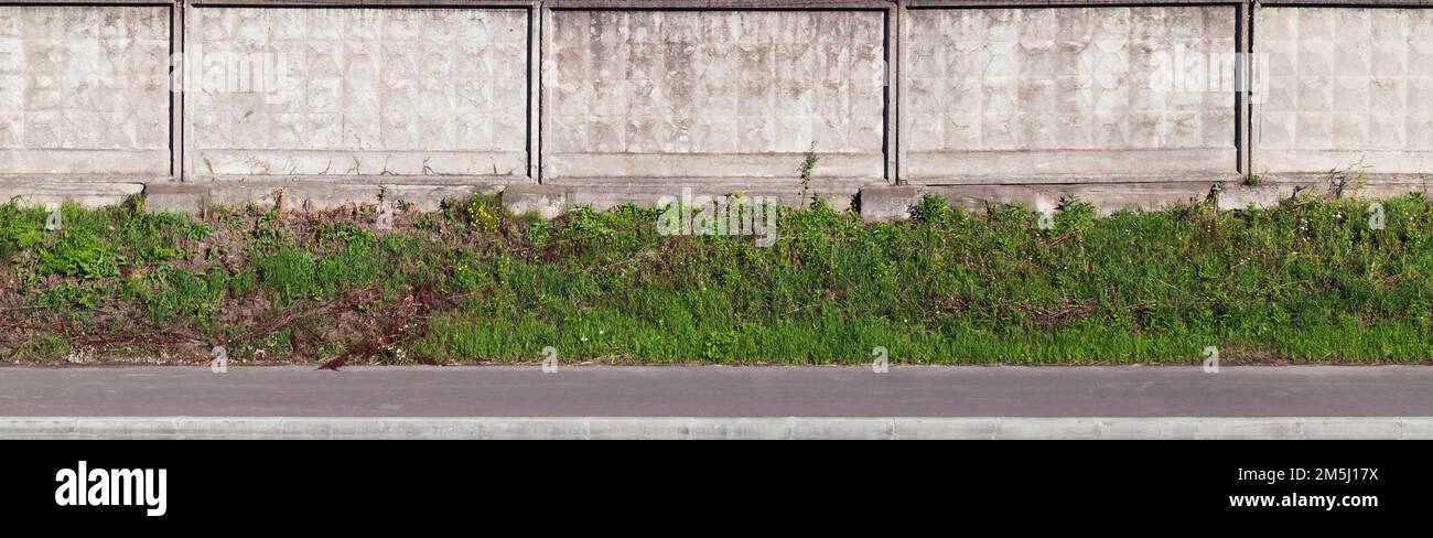 Gray industrial concrete fence on a roadside, wide panoramic background ...