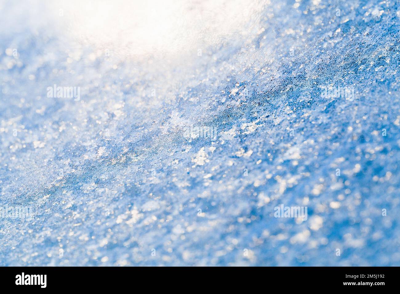Shiny blue frost and ice crystals on a window glass. Abstract ...