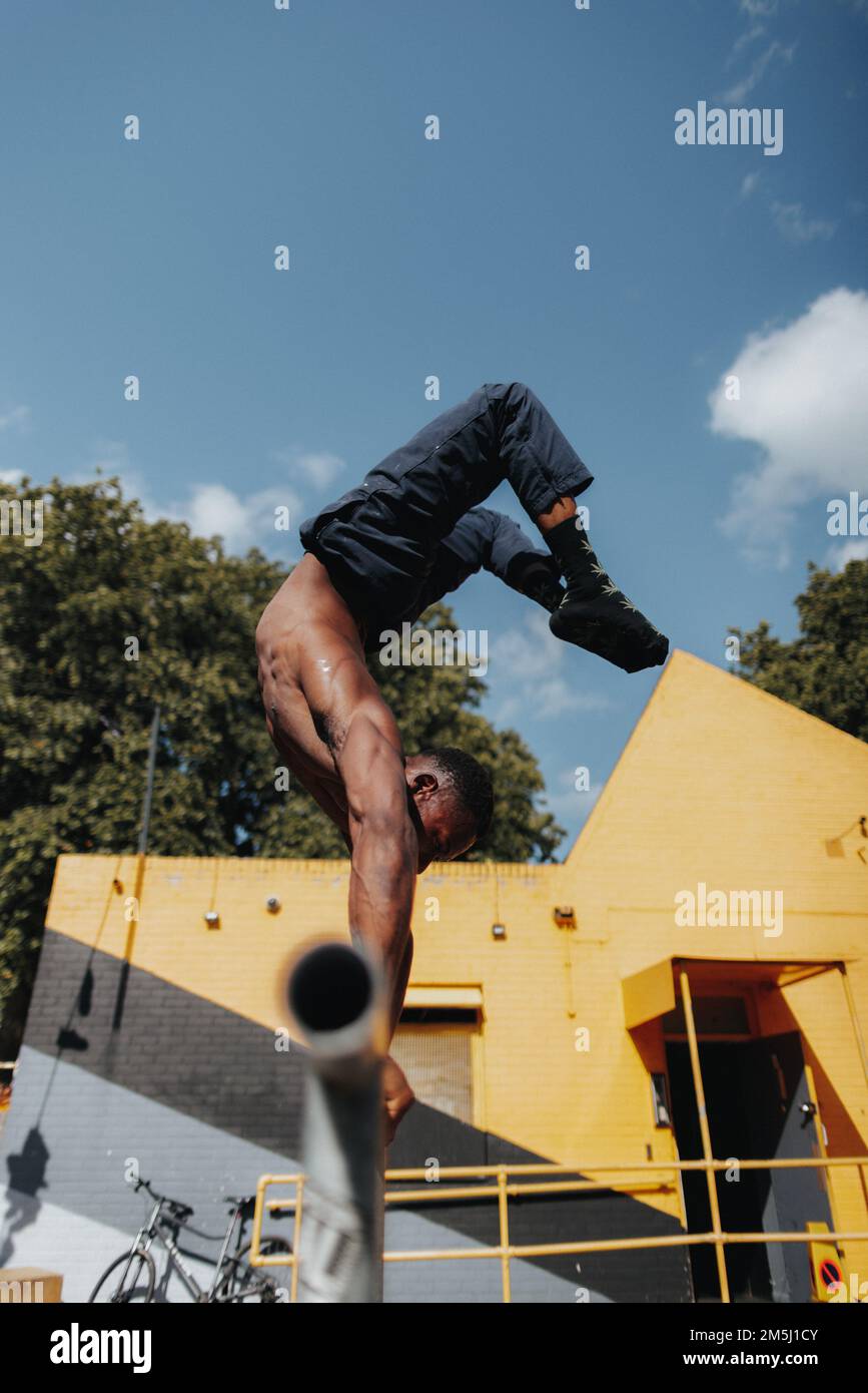 A portrait of a person doing an upside-down position for the exercise ...