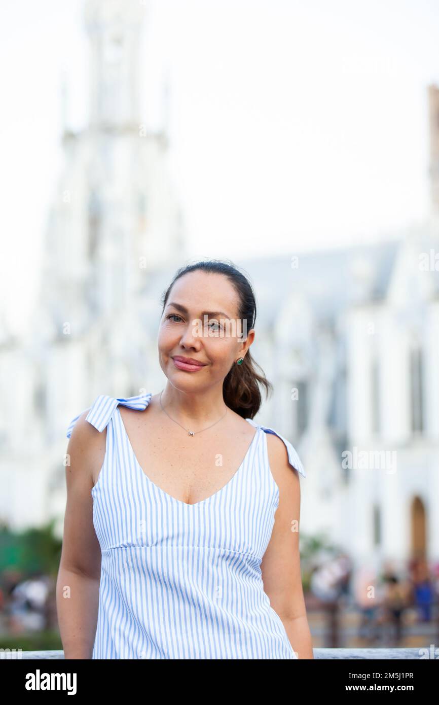 Beautiful tourist woman at the Ortiz Bridge with La Ermita church on ...