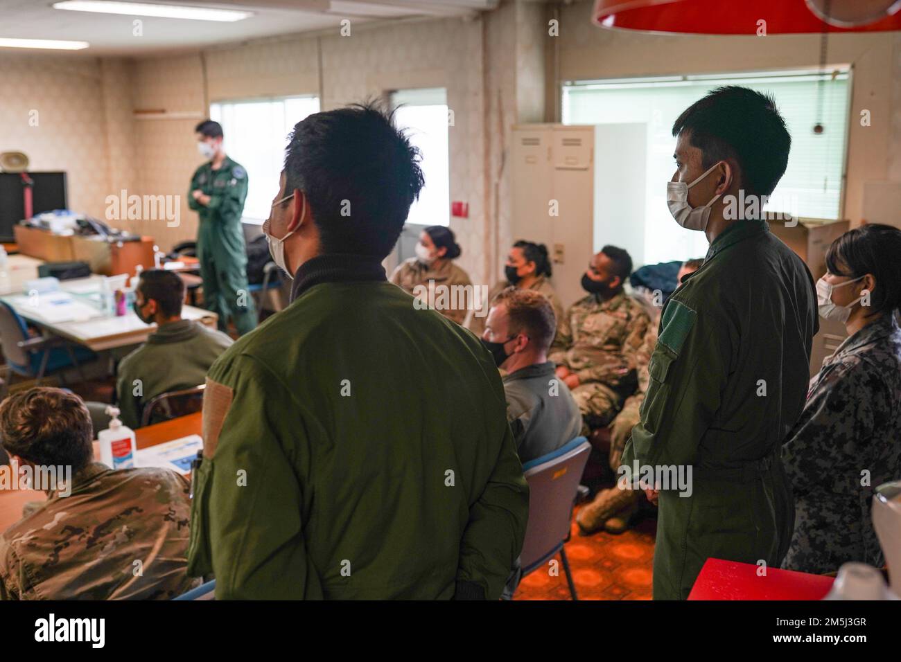 Two Japan Air Self-Defense Force pilots listen to a briefing by Lt. Col ...