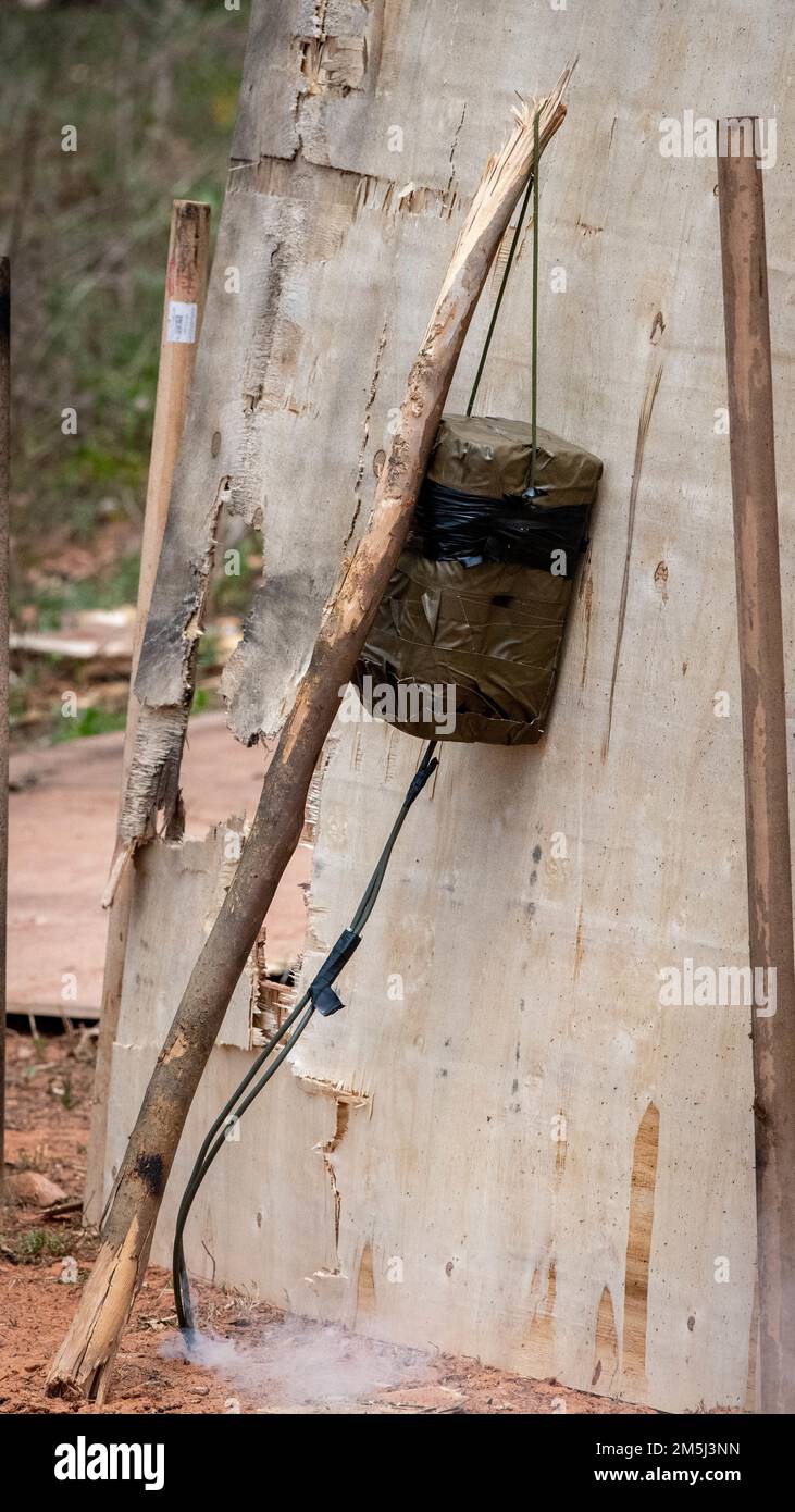 The fuse on a water breaching charge burns on a simulated door, Mar. 18 ...