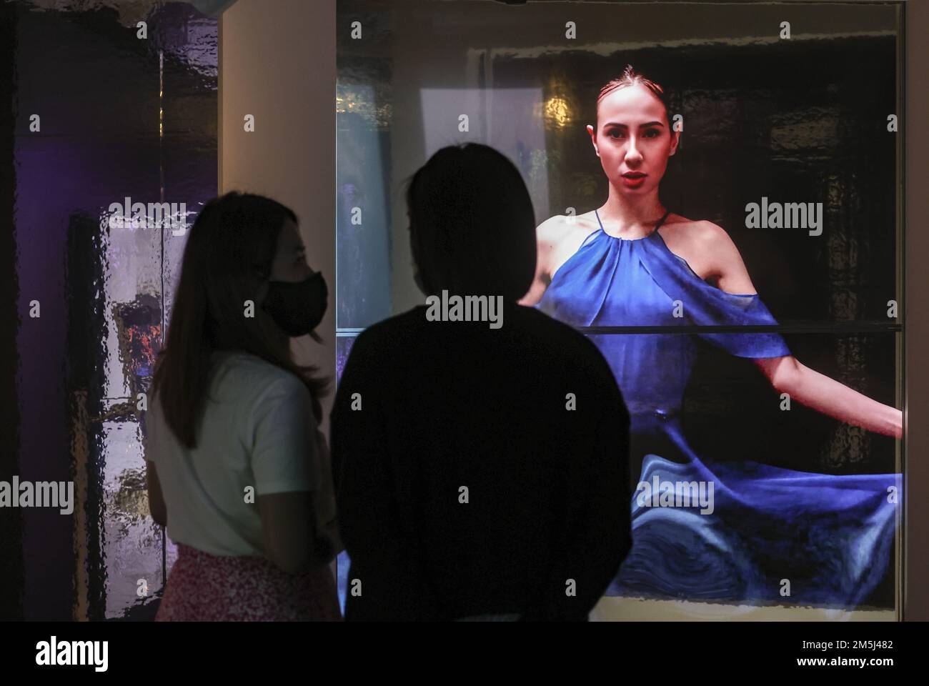 Visitors looking at an NFT art installation titled HHhroup my AisHHby ...
