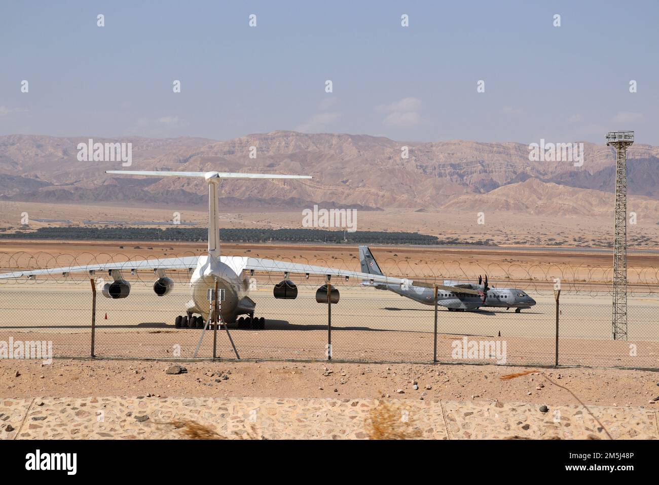 A passenger plane at the airport and a warplane belonging to the ...