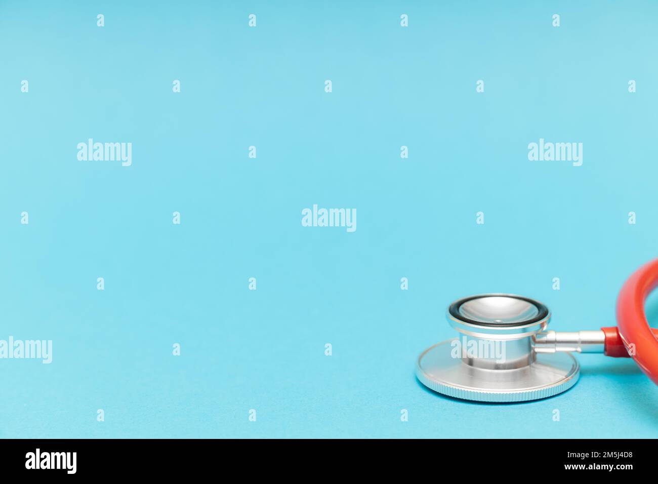 medical stethoscope on a blue background shot with blur Stock Photo - Alamy