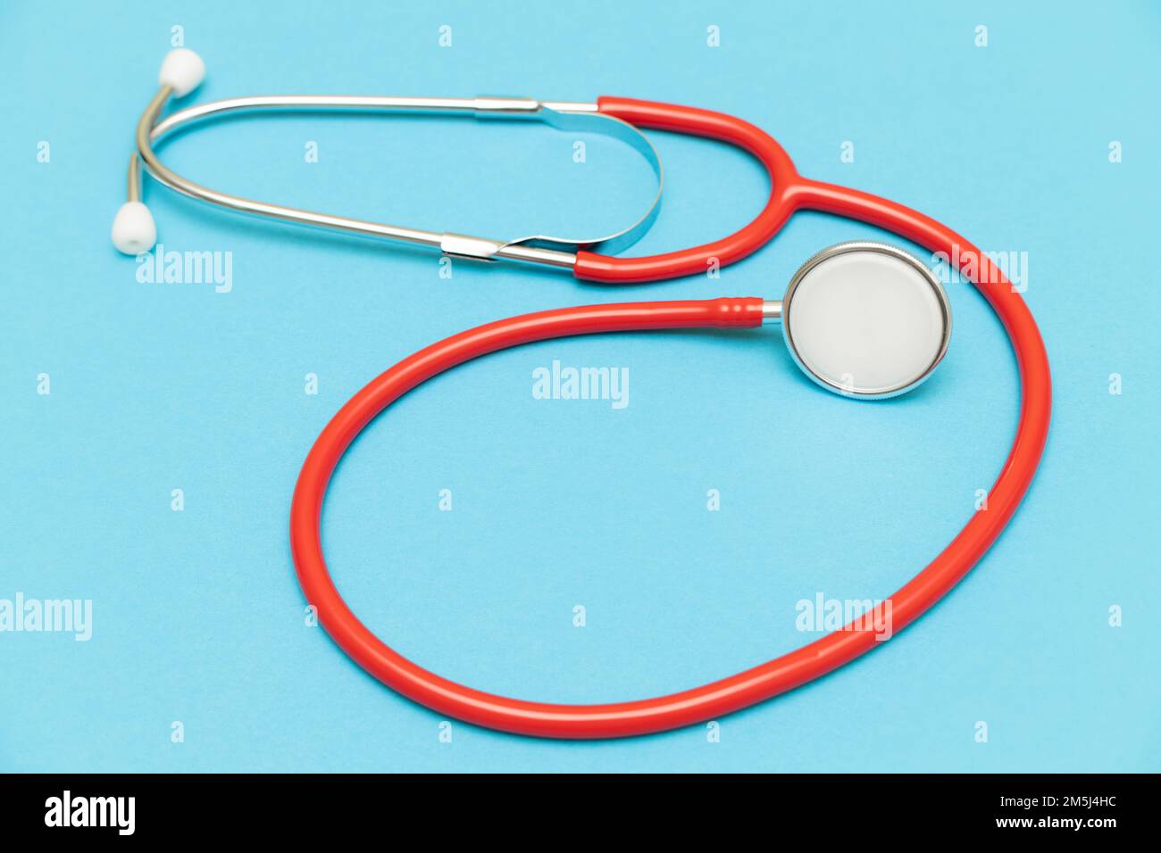 medical stethoscope on a blue background shot with blur Stock Photo - Alamy