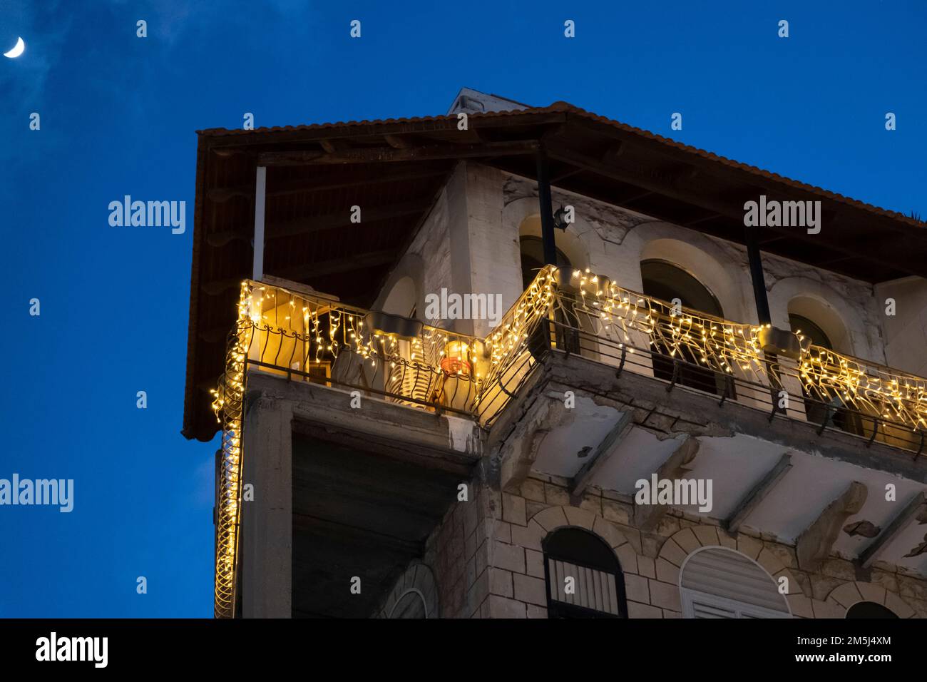 String lights decorate a balcony of a house in the German colony ...