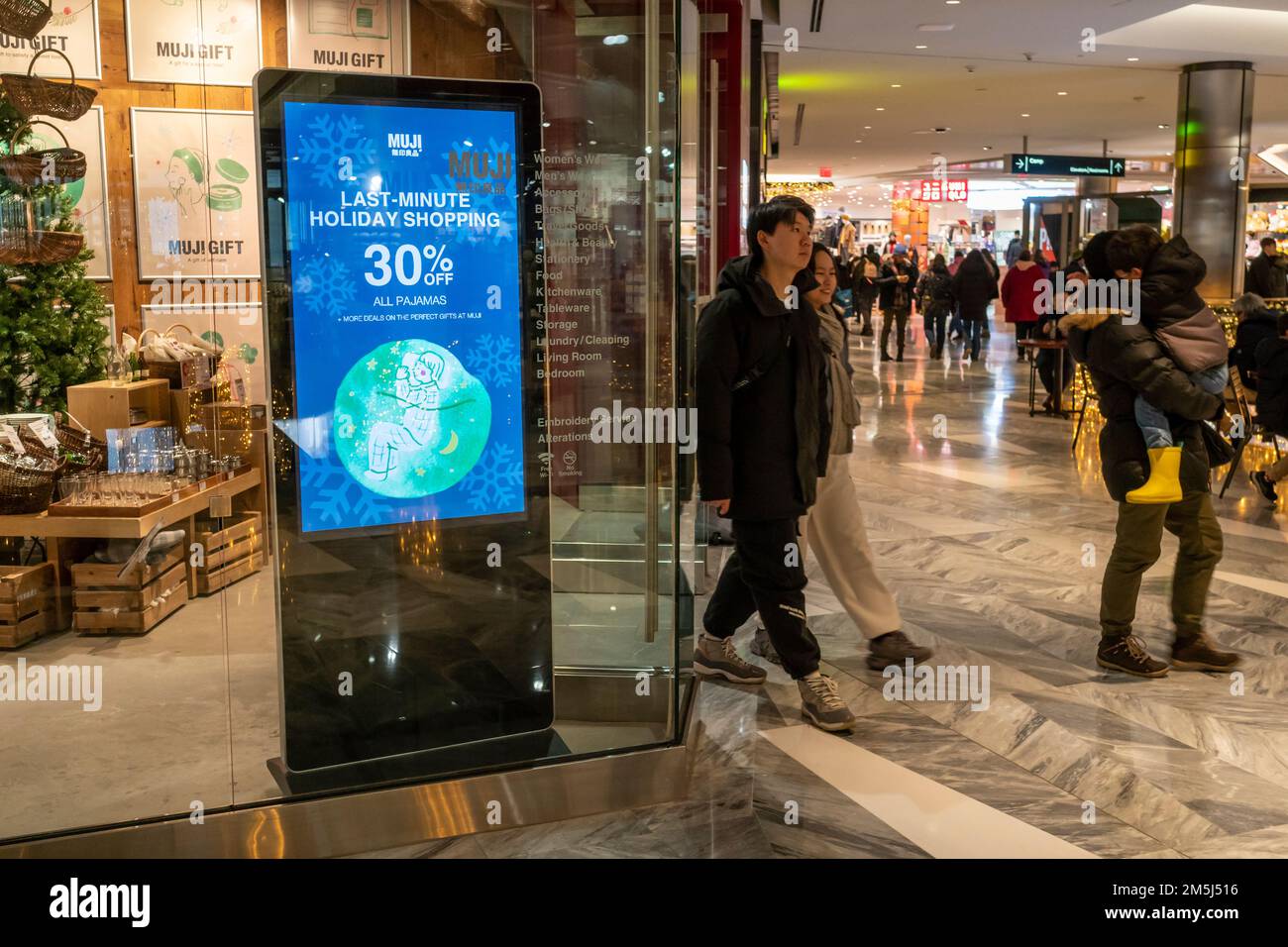 Tourists and last minute shoppers get out of the bitterly cold weather ...
