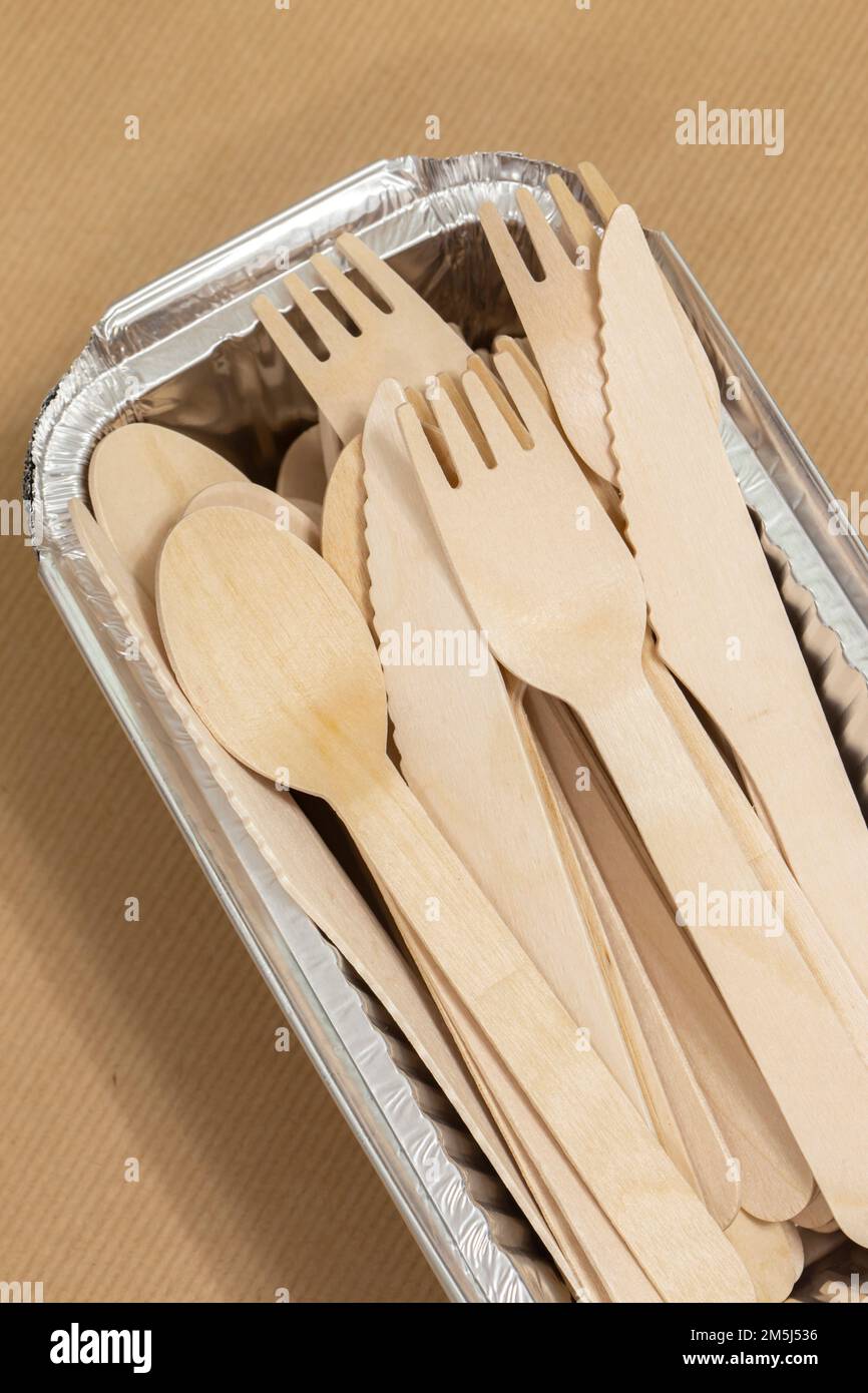 Wooden takeaway cutlery, knife fork spoon, in foil tray containers on ...