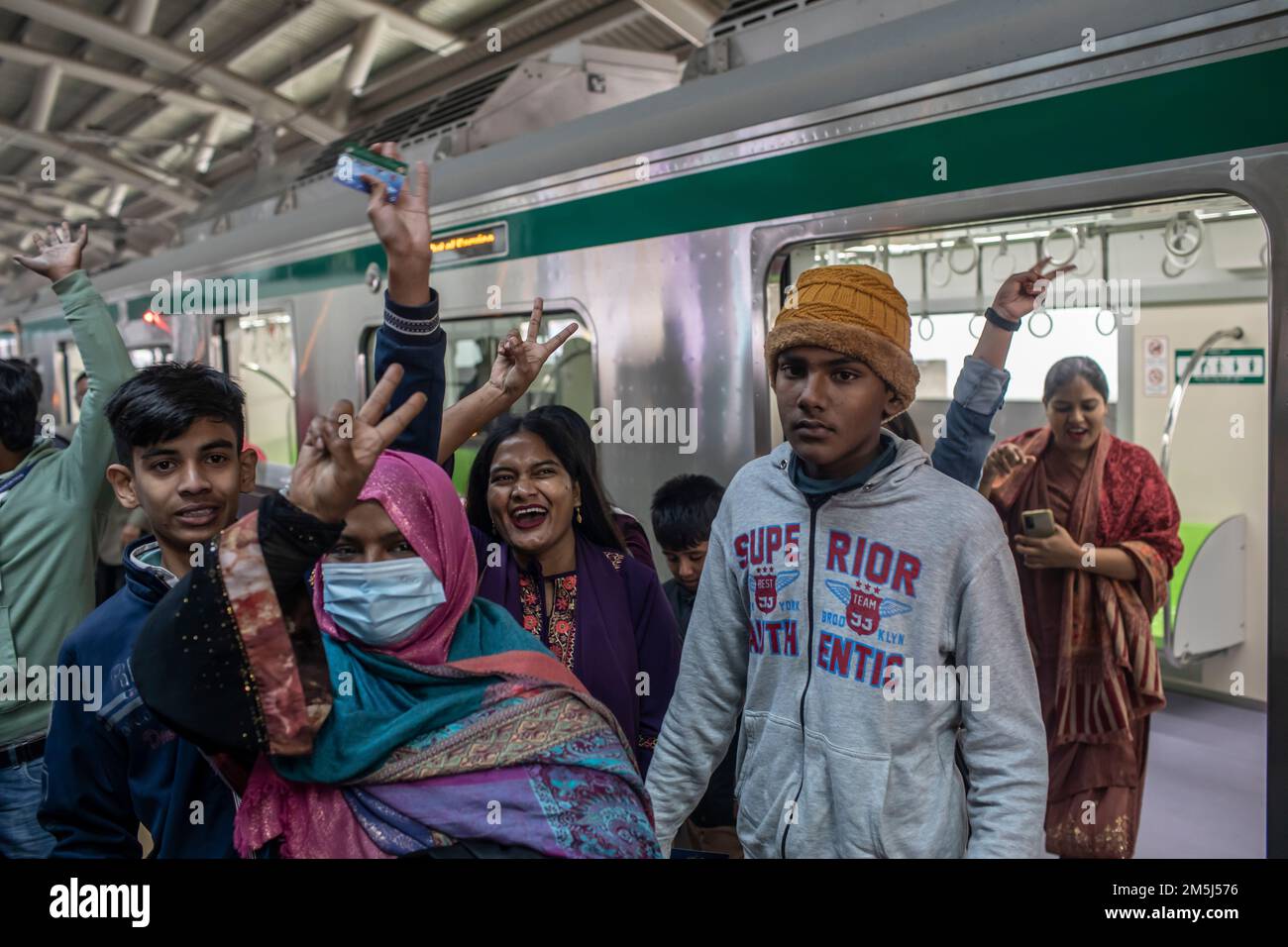 Passengers express their happiness during the ride at the metro rail ...