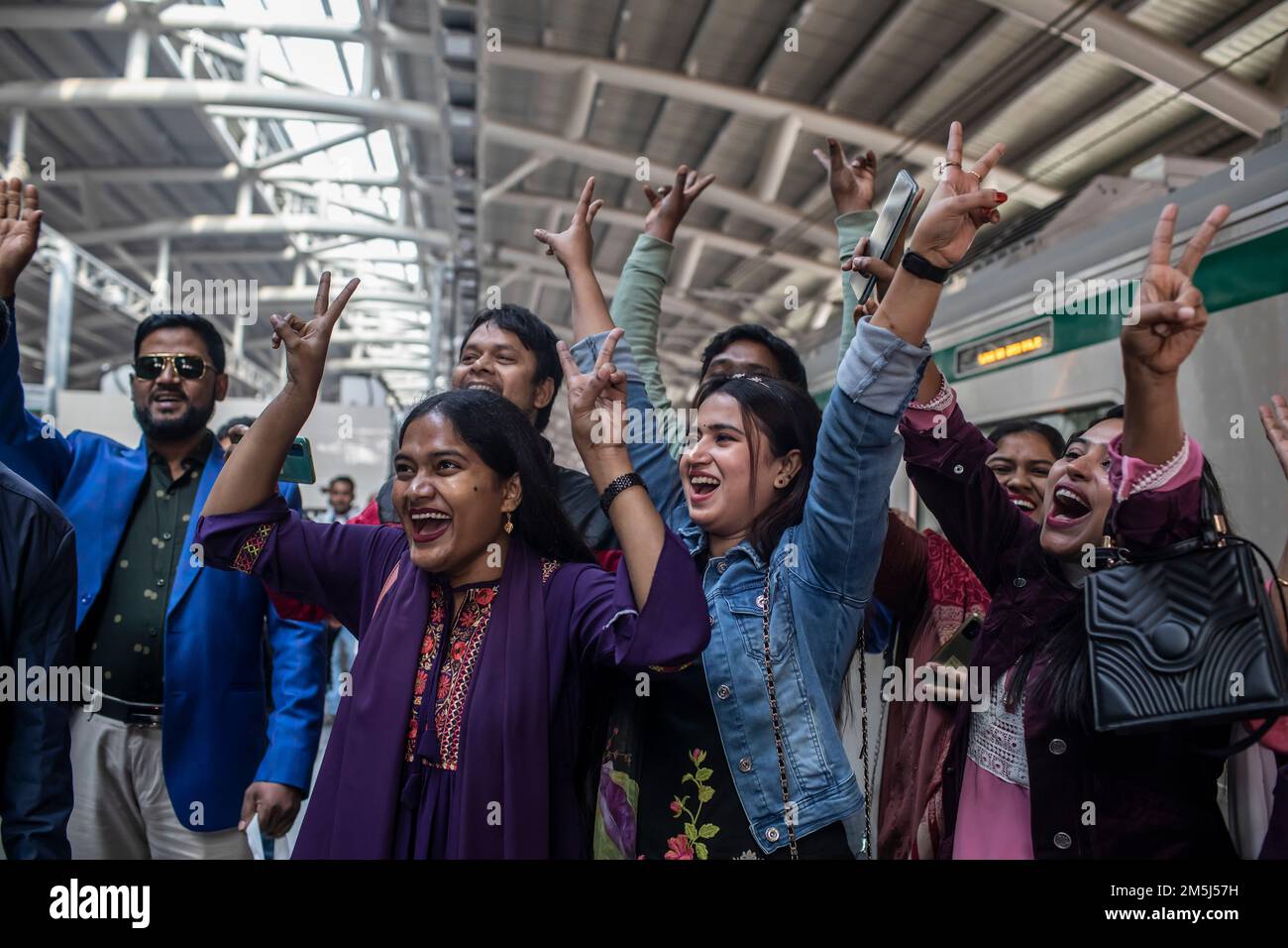 Passengers express their happiness during the ride at the metro rail ...