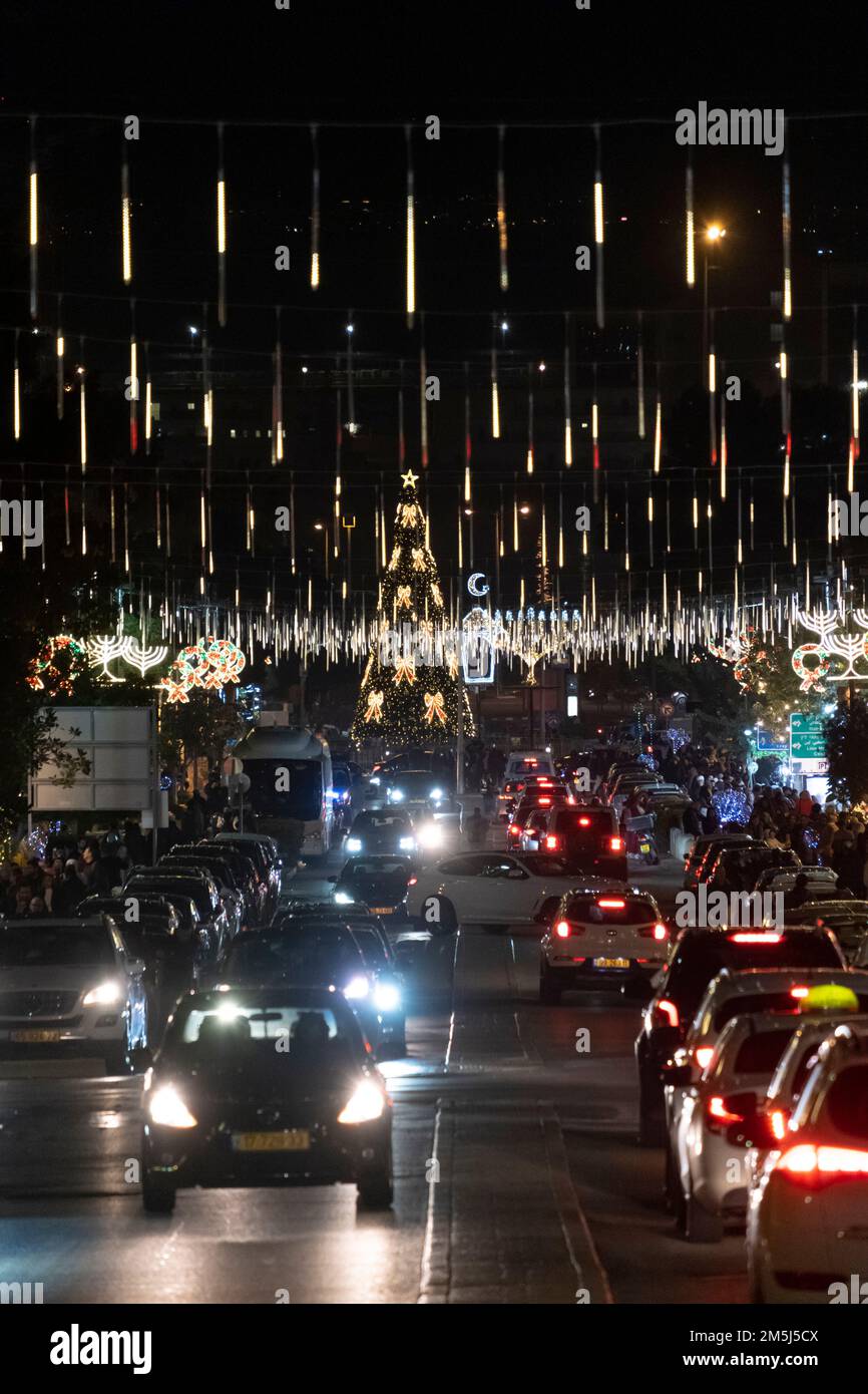 A decorated Christmas tree with illuminated Hanukkah menorah and the ...
