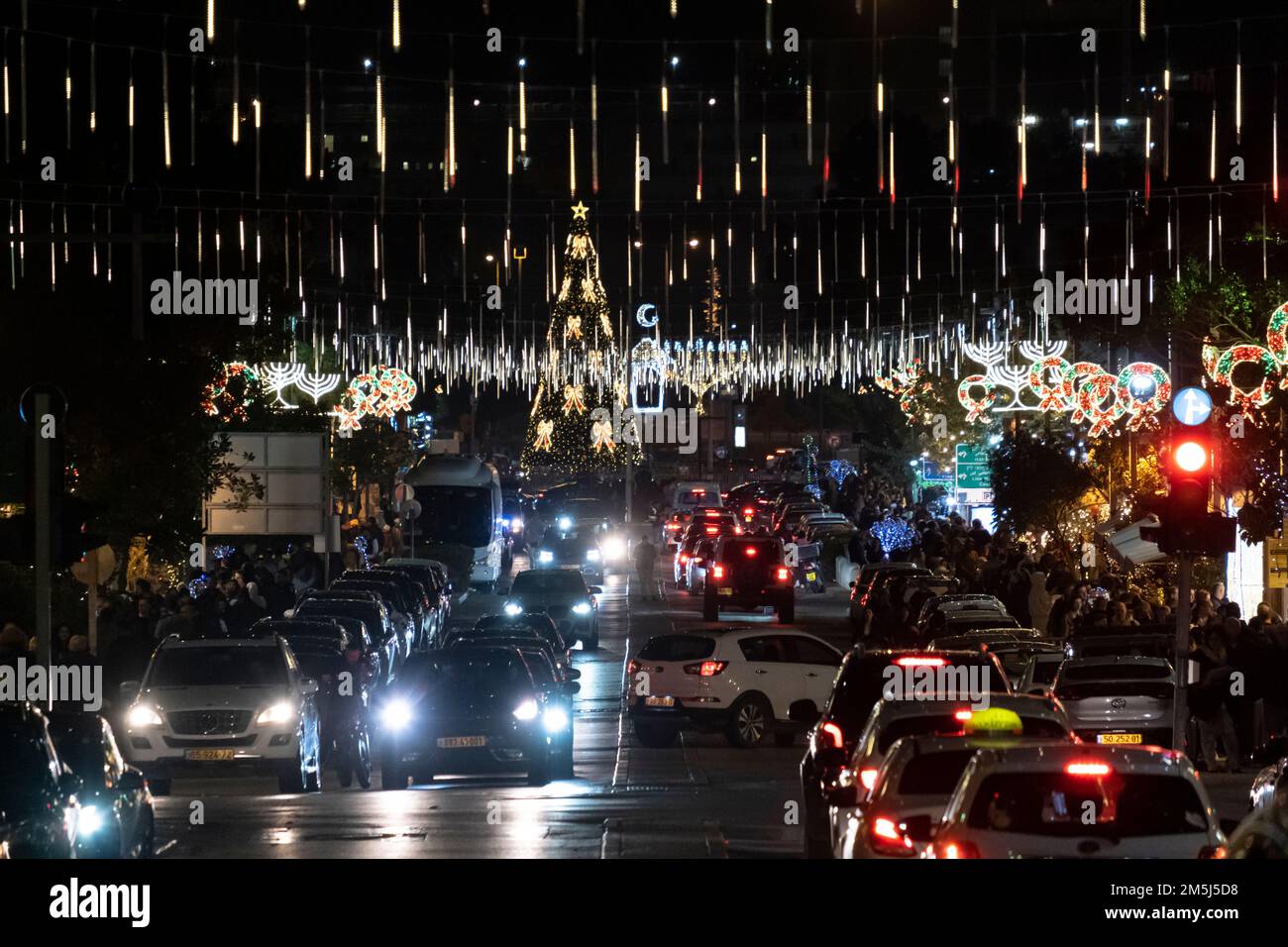 A decorated Christmas tree with illuminated Hanukkah menorah and the ...