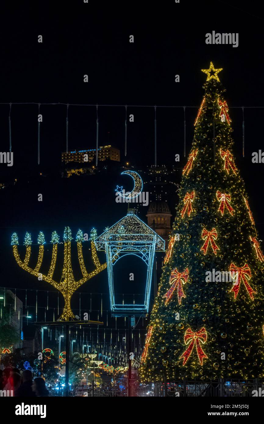 A decorated Christmas tree with illuminated Hanukkah menorah and the ...