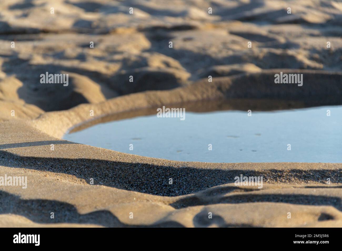 Water disappearing in sand on the beach, global warming, water shortage ...