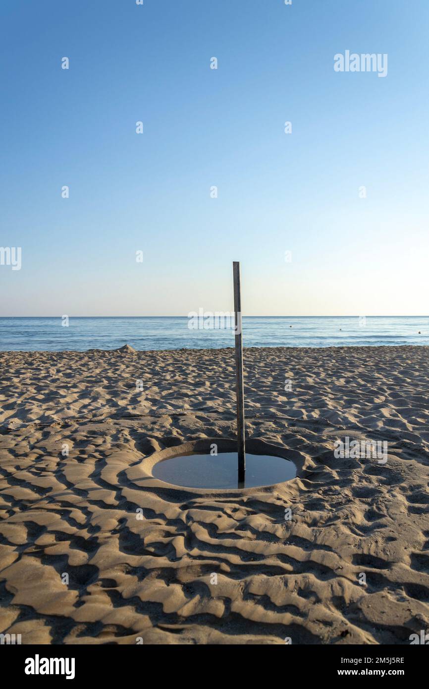 Water disappearing in sand on the beach, global warming, water shortage ...