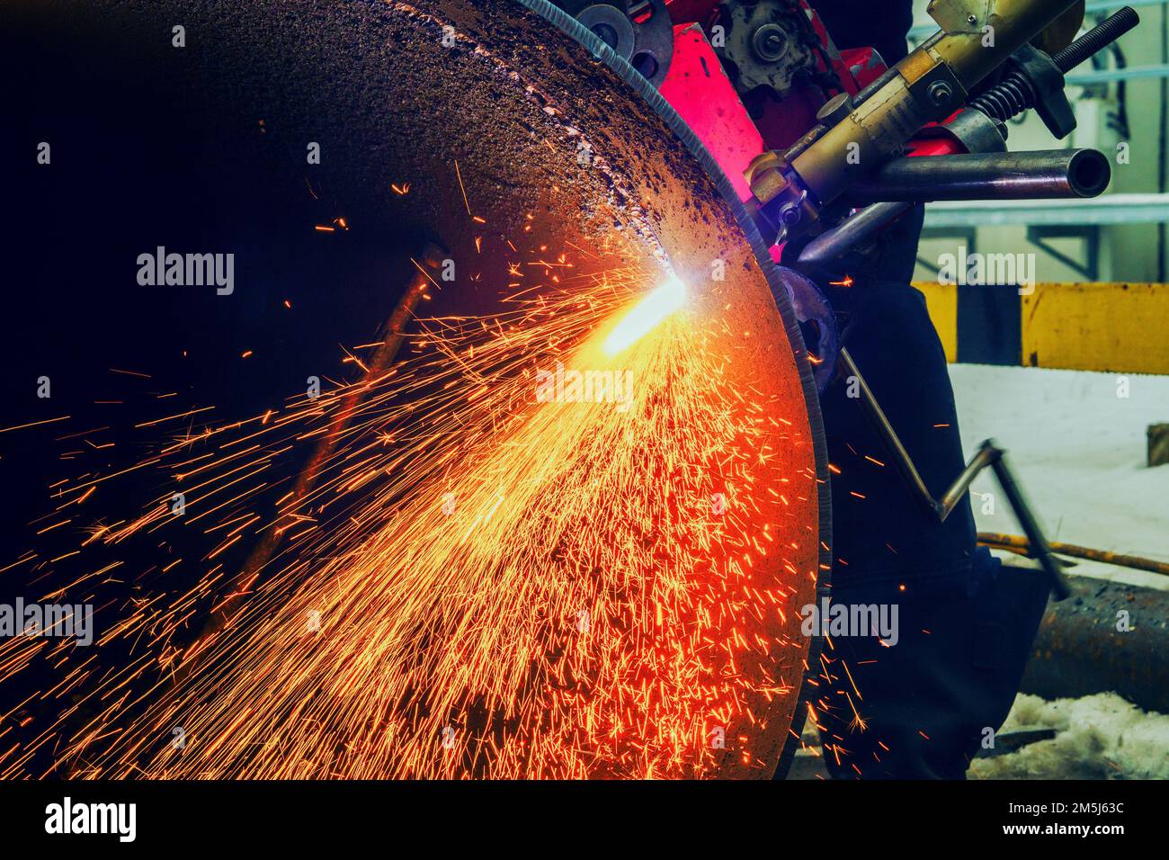 Working welder cuts metal and sparks fly. Gas cutting of large diameter ...