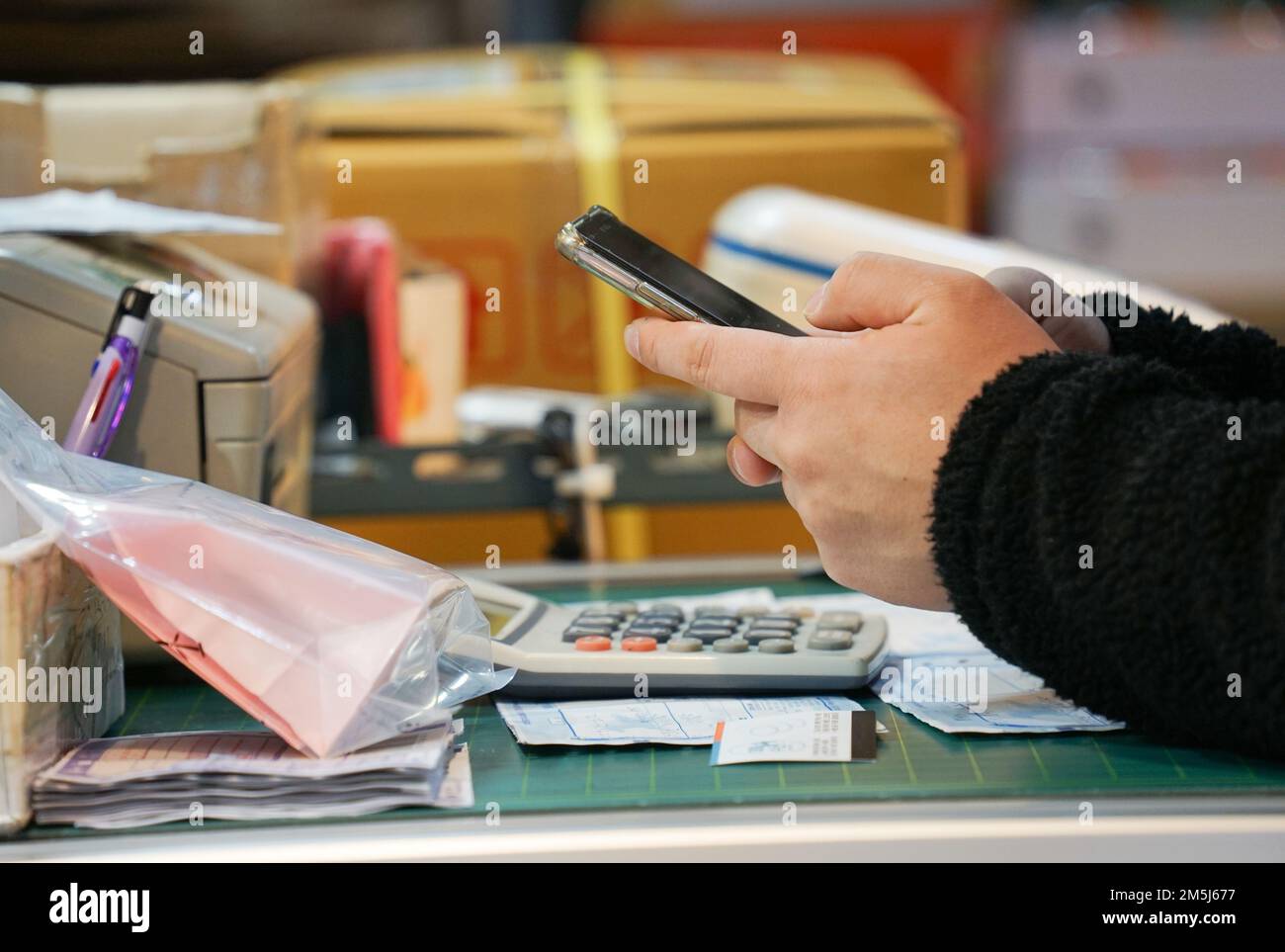 A person playing with a cell phone Stock Photo - Alamy