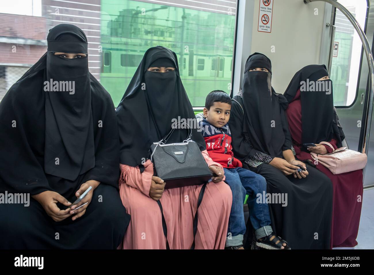 Dhaka, Bangladesh. 29th Dec, 2022. Passengers travel inside a Dhaka ...