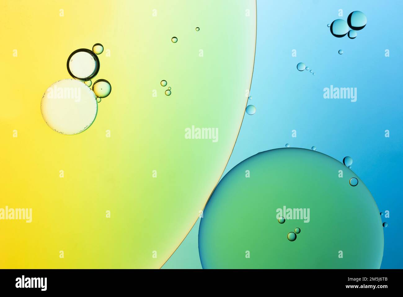 Multi-coloured bubble patterns formed by oil floating on water Stock ...