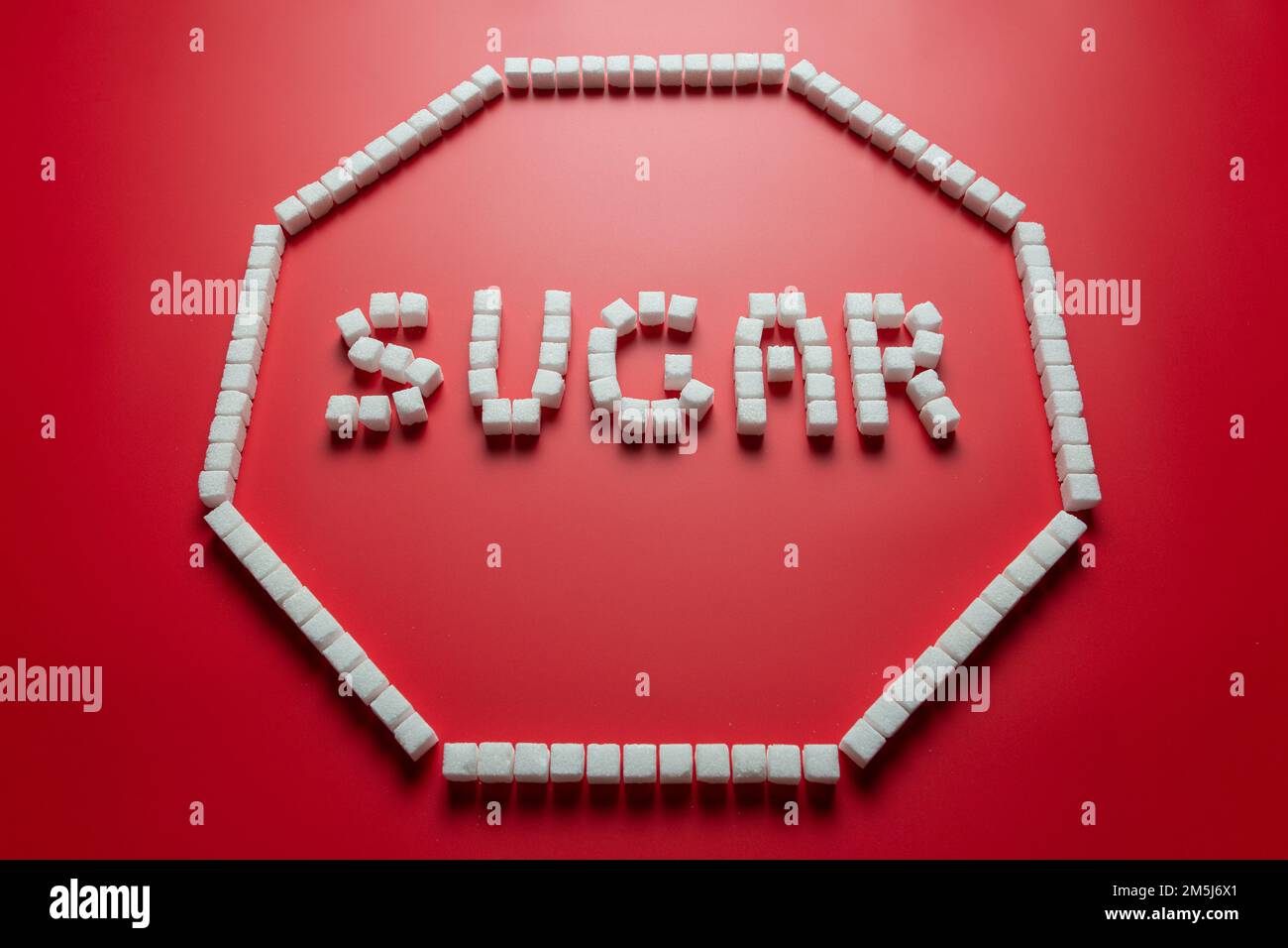 octagonal frame in the form of a stop sign made of sugar cubes with red ...