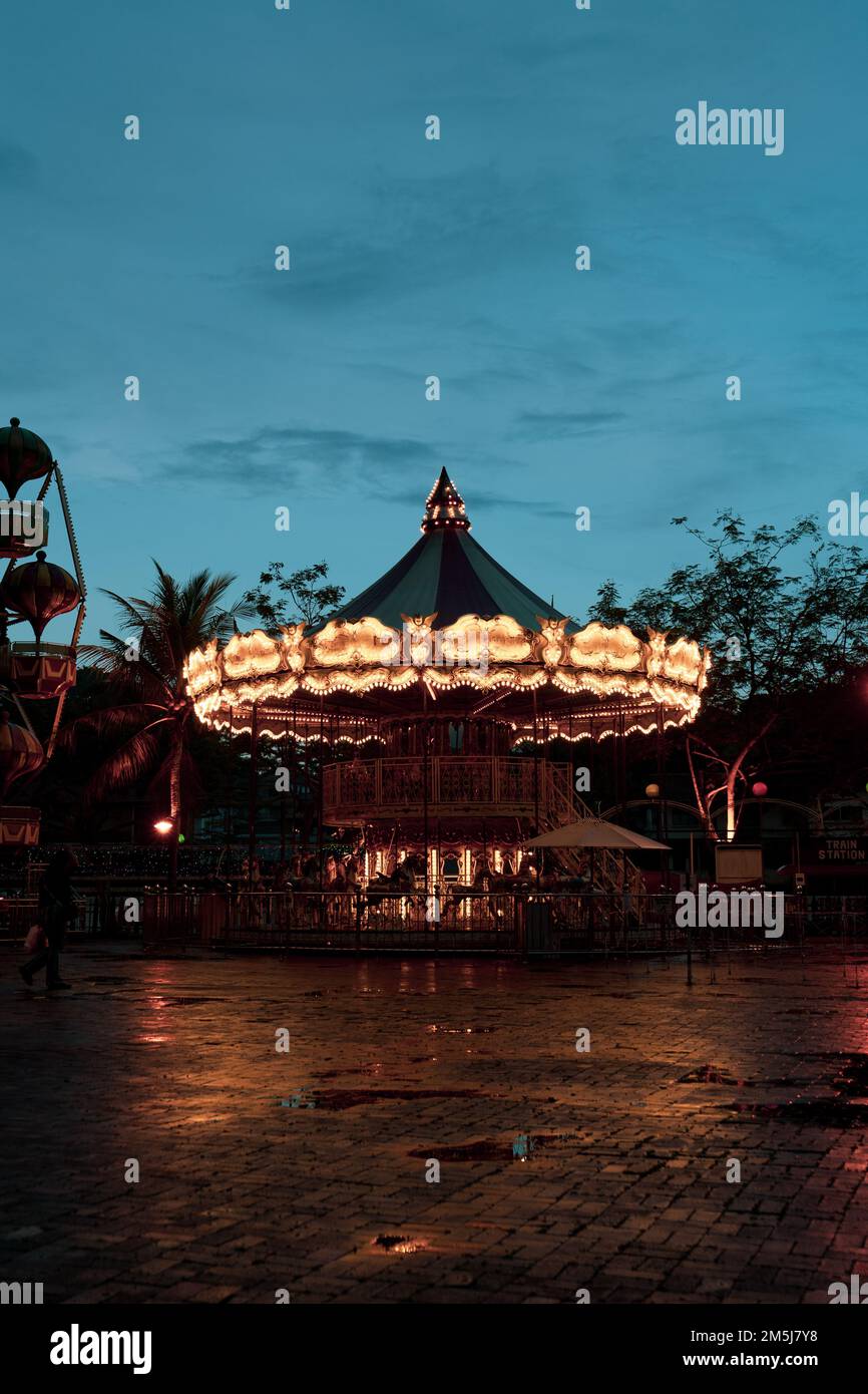 A Night carousel at Danga Bay funfair, vertical Stock Photo - Alamy