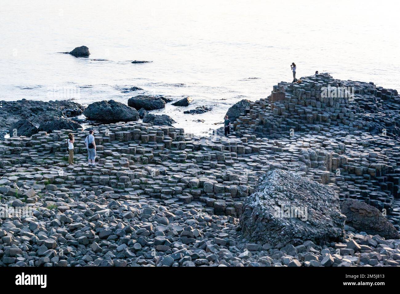 Some people at the Giant's Causeway in County Antrim, Northern Ireland ...