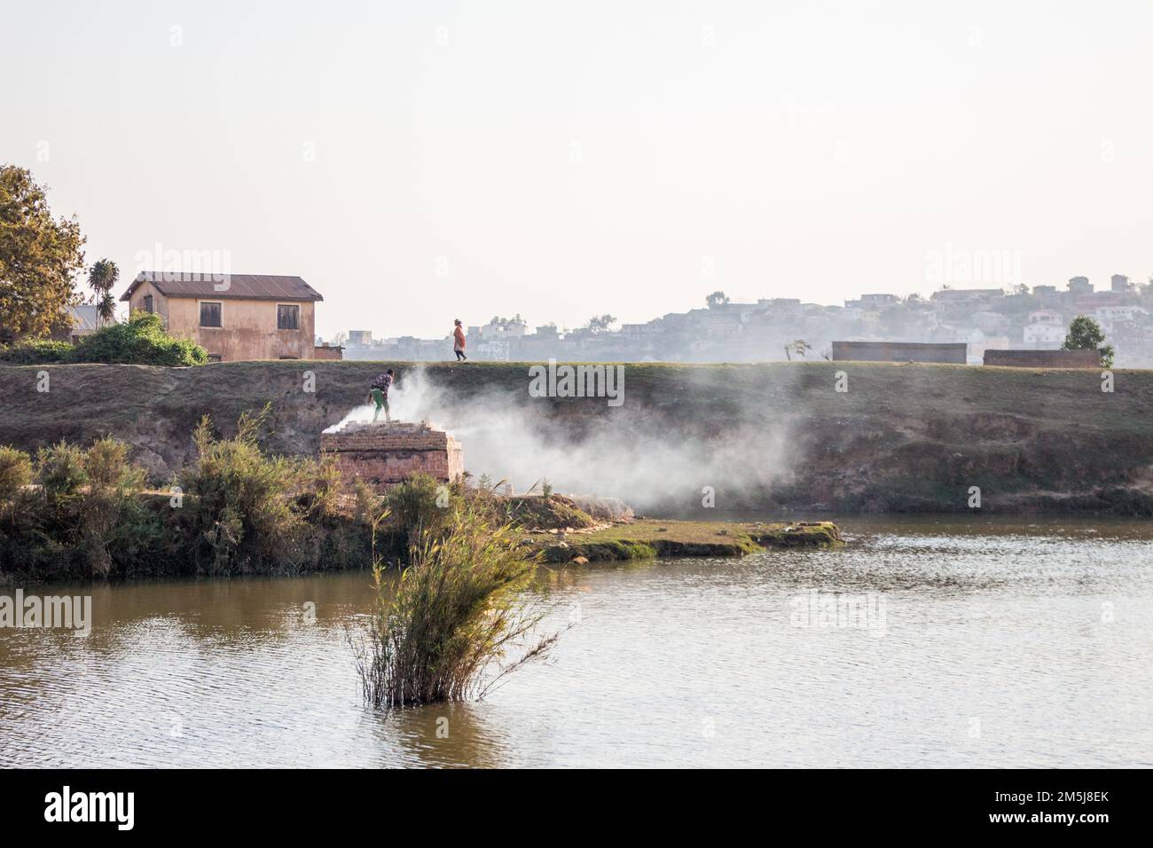 The view of a brickmaker working on a riverbank in Madagascar Stock ...