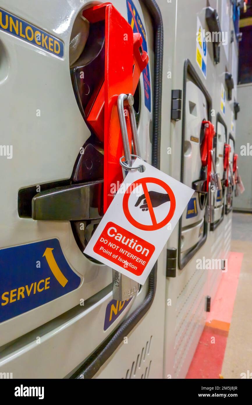 Caution point of isolation label and lock on electrical equipment Stock ...
