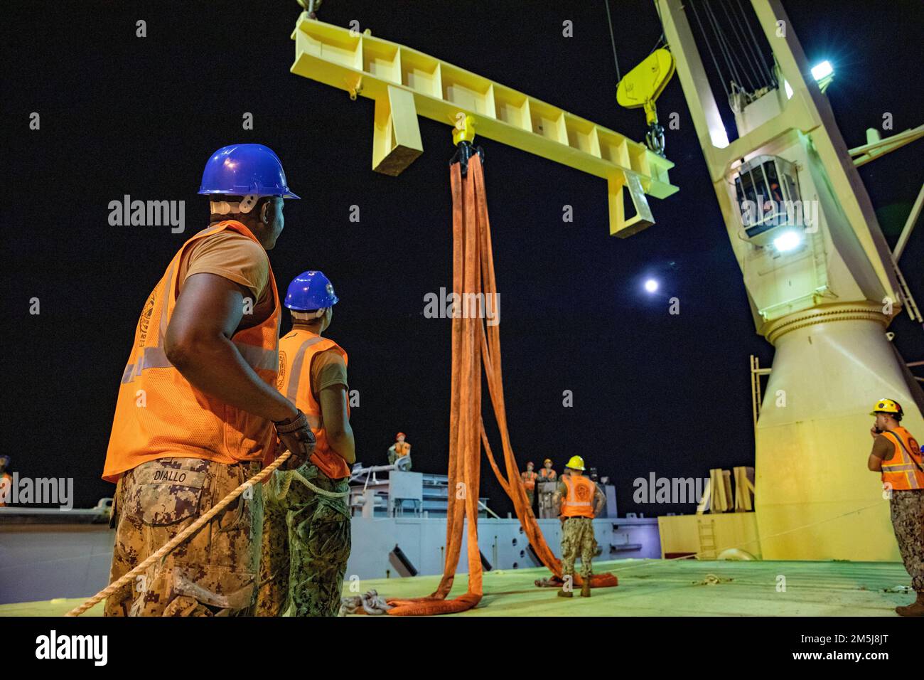 U.S. Navy Sailors with Navy Cargo Handling Battalion 1, guide a quad ...