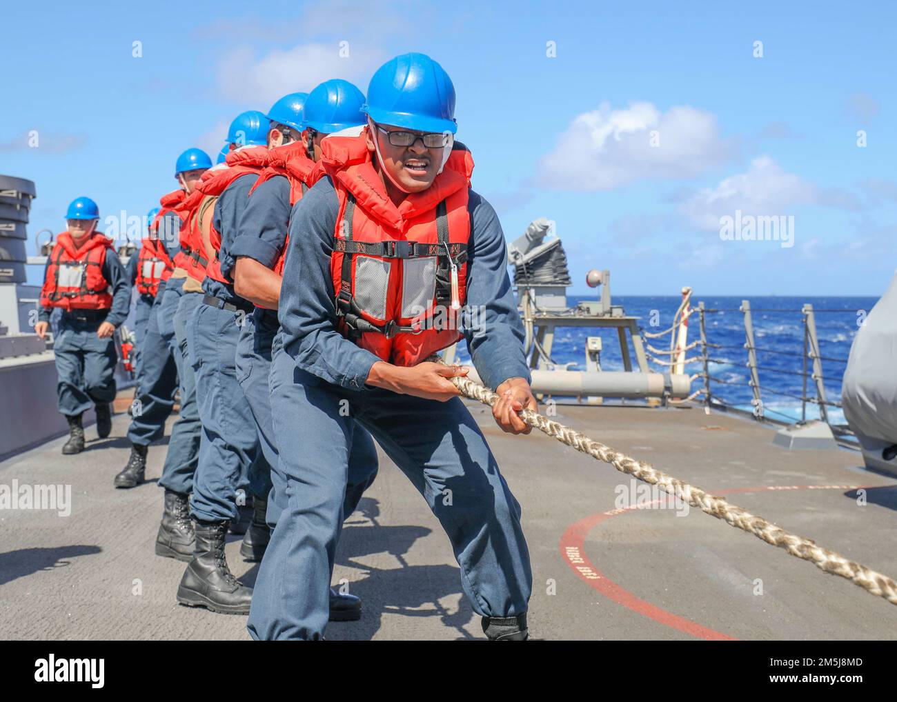 PHILIPPINE SEA (March 18, 2022) Sailors heave a line on the fantail of ...