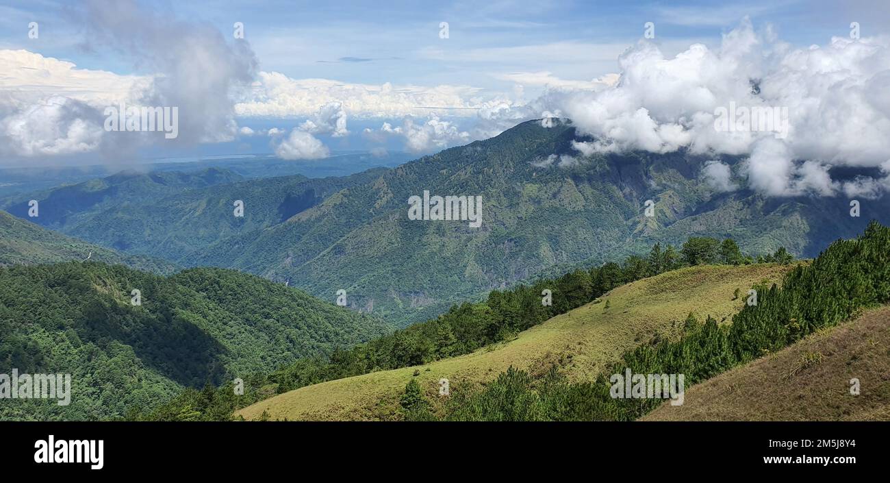 A beautiful panoramic view of green forested hills on a sunny summer ...
