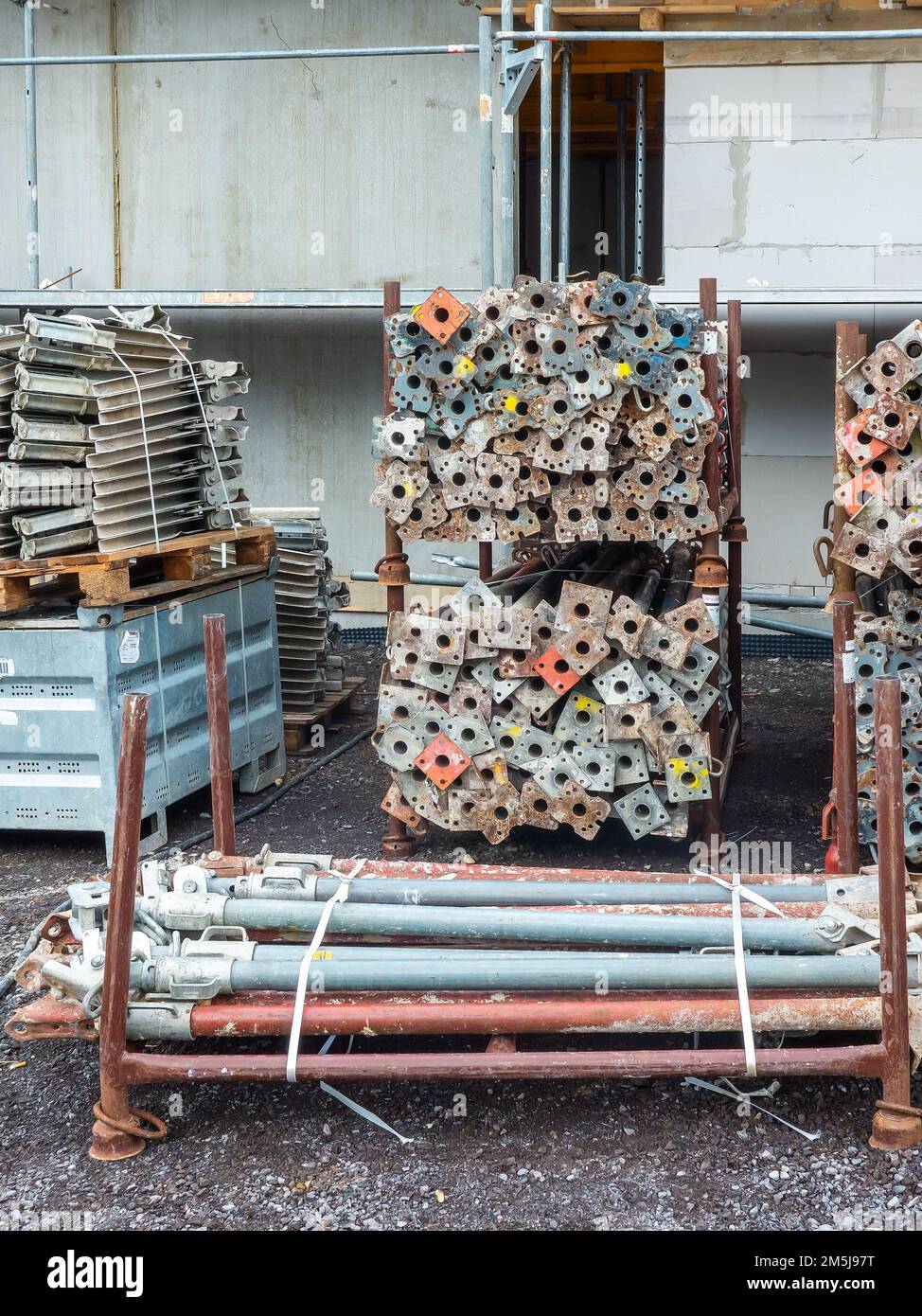 Piles of steel columns and other construction materials on a building ...