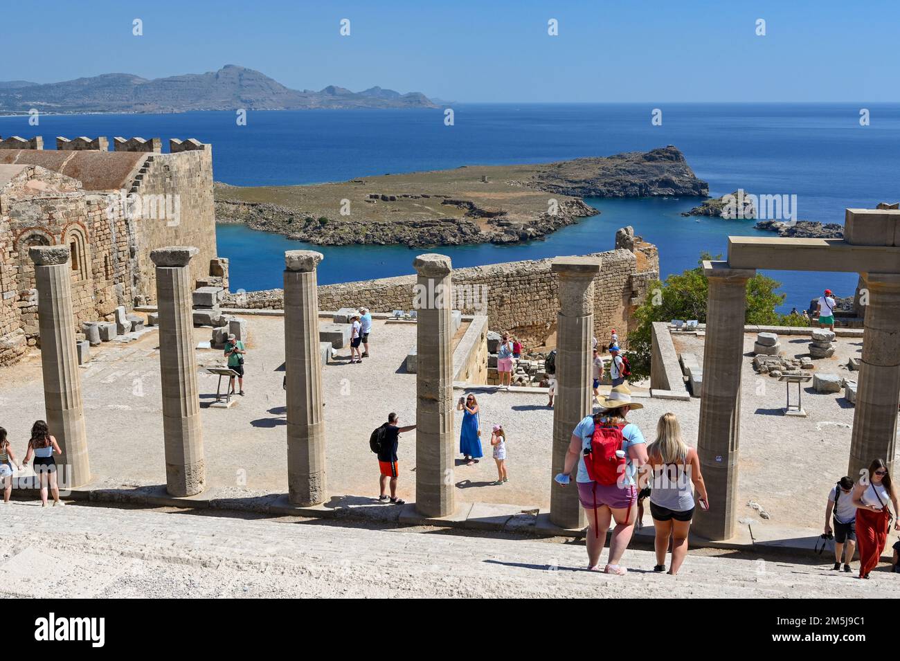 Lindos, Rhodes, Greece - May 2022: Tourists visiting the ancient ruins ...