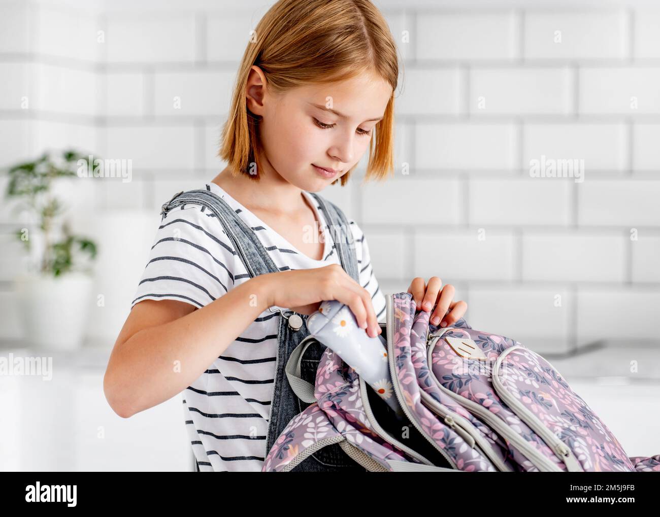 Girl preparing backpack Stock Photo - Alamy