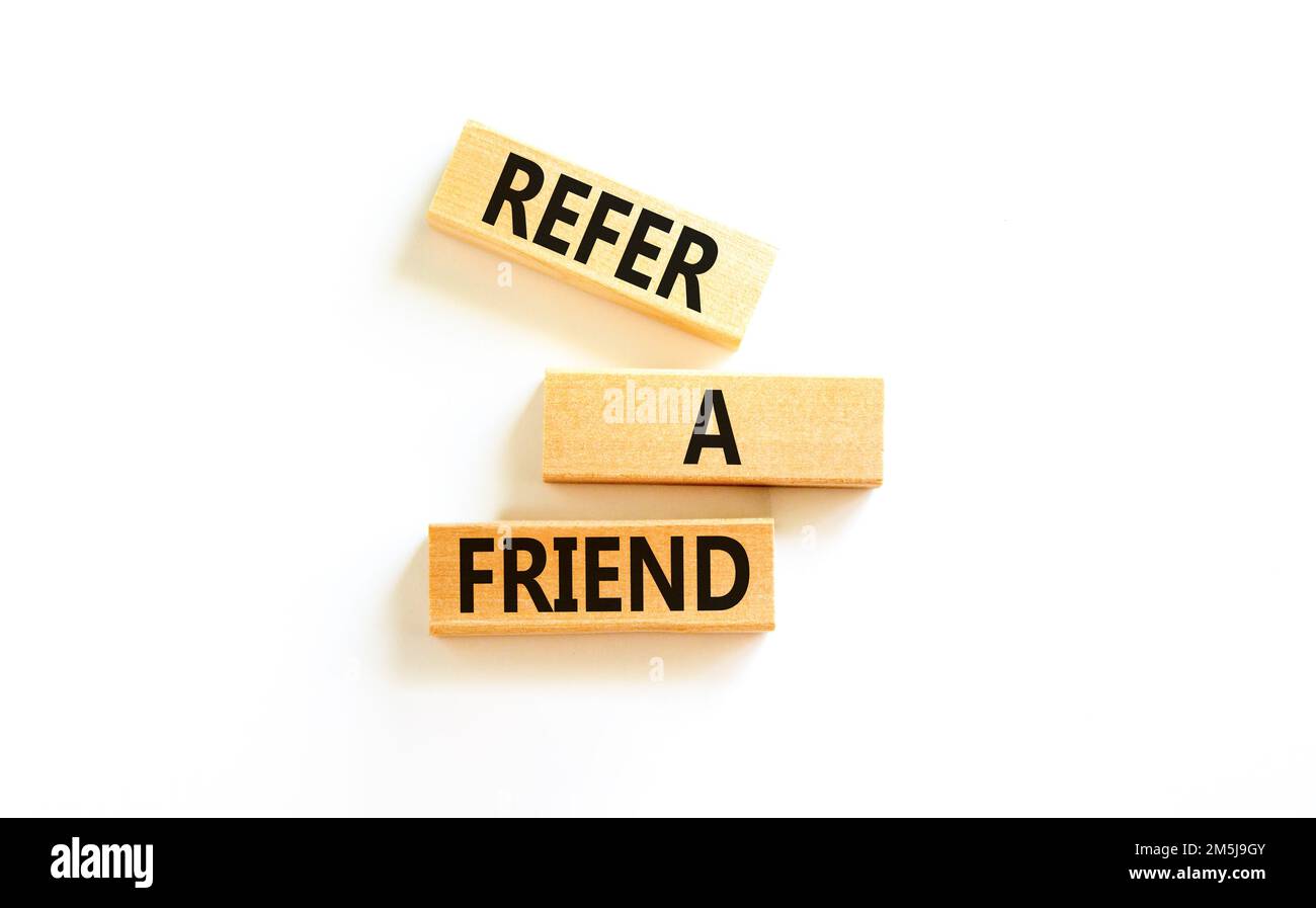 Refer a friend symbol. Concept words Refer a friend on wooden blocks on ...