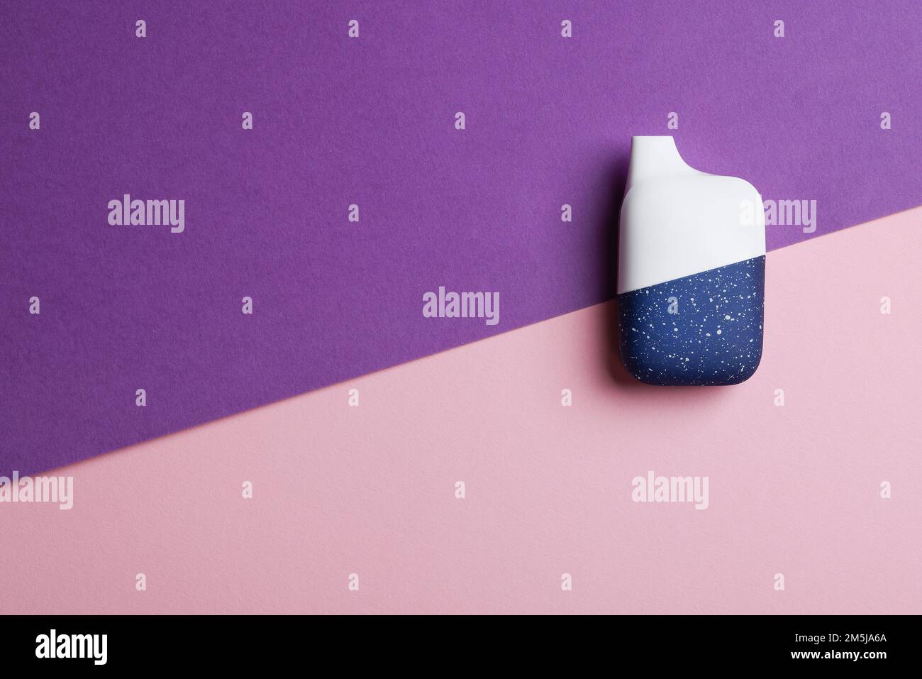 disposable electronic cigarette or vape on purple background. top view ...