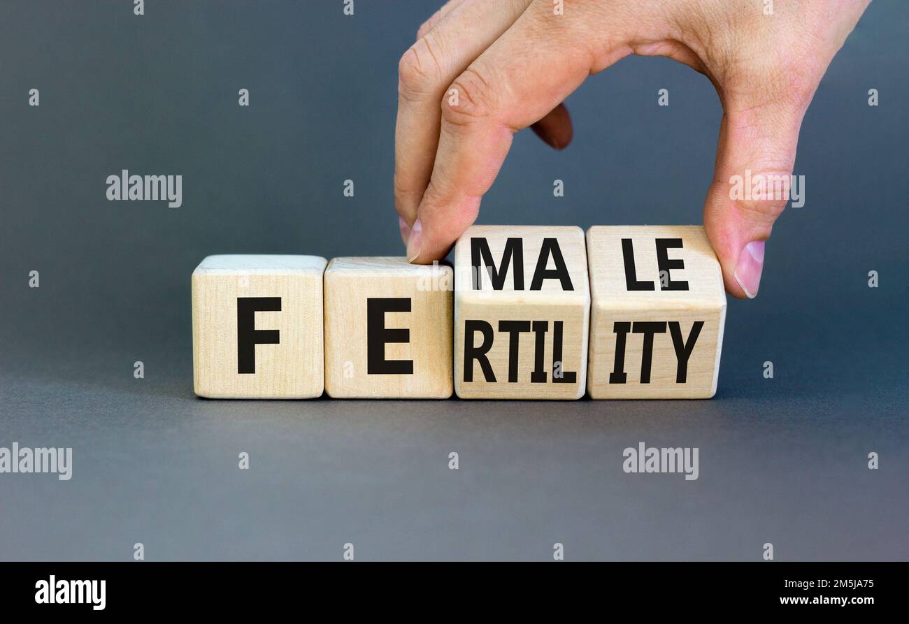 Female fertility symbol. Concept word Female fertility on wooden cubes ...